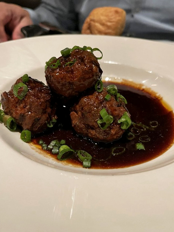 Meatballs that could make an Italian grandmother weep with joy. Swimming in a rich, glossy sauce and topped with fresh scallions—comfort food elevated.