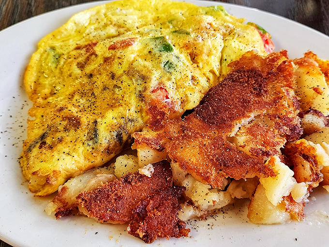 This omelet doesn't just sit on the plate&mdash;it lounges confidently beside those gloriously crispy home fries like it knows it's the star of the show.
