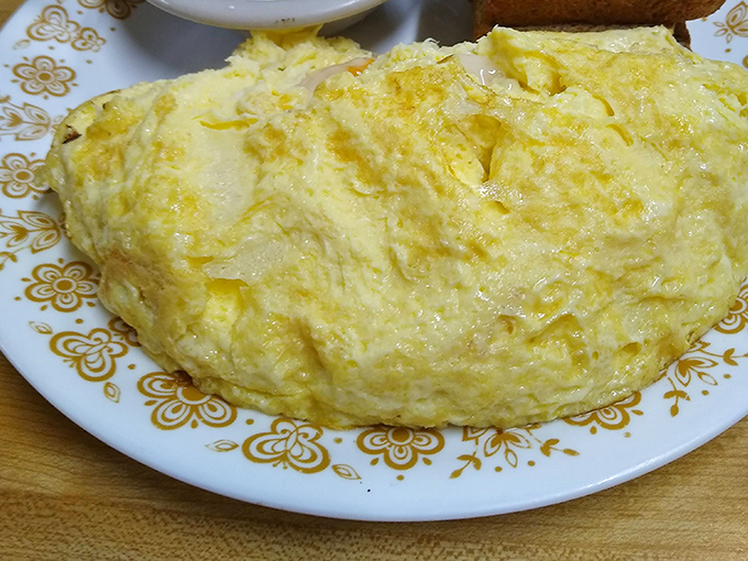 Sunshine on a plate! This omelet has that perfect yellow hue that screams "farm-fresh eggs" and "your diet starts tomorrow."