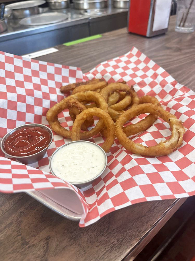 Golden onion rings that crackle with each bite, served with dipping sauces in red checkered baskets&mdash;diner perfection that needs no filter.