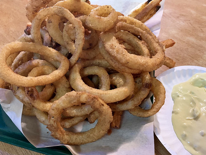 Onion rings stacked like delicious golden halos&mdash;crispy, substantial, and making a compelling case for their own food group.