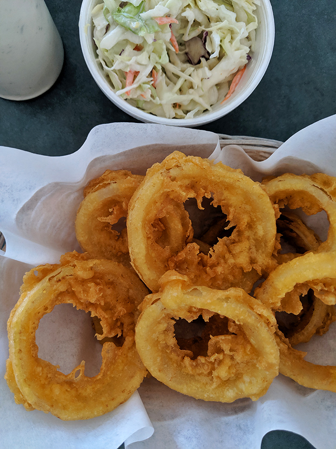 Onion rings that achieve the perfect crunch-to-softness ratio, paired with creamy coleslaw that cuts through the richness. Balance in all things!