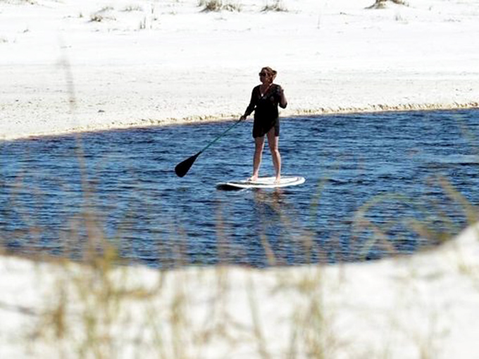 Finding your balance on Western Lake. Paddleboarding here is like gliding across a mirror that perfectly reflects your "I should do this more often" smile.