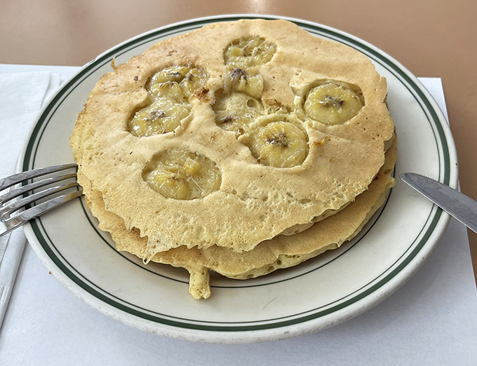 Pancakes that double as banana delivery vehicles, golden-brown and perfectly sized for soaking up maple syrup without surrendering their structural integrity.