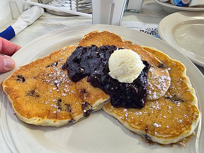 Blueberry pancakes topped with a scoop of butter and berry compote&mdash;proof that Wisconsin knows how to turn breakfast into an art form.