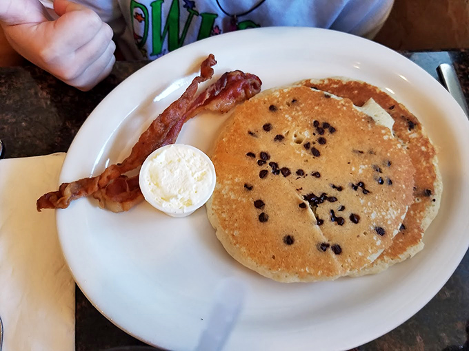 Blueberry pancakes with the perfect distribution of fruit—no disappointing empty patches here—just fluffy, golden joy that makes morning people out of night owls.