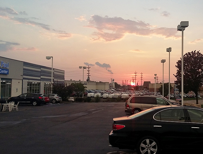 Even at sunset, the St. Vincent de Paul parking lot buzzes with activity. The golden hour glow makes even this utilitarian space look like a retail promised land.