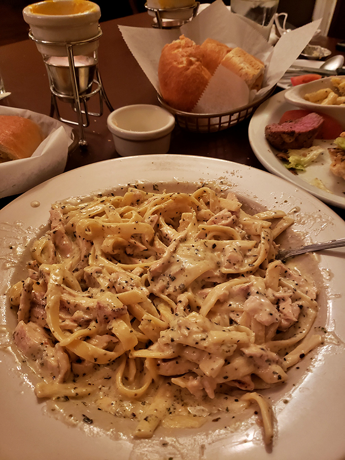 Fettuccine that knows exactly what it's doing—embracing chicken in a creamy sauce that would make an Italian grandmother weep with joy.