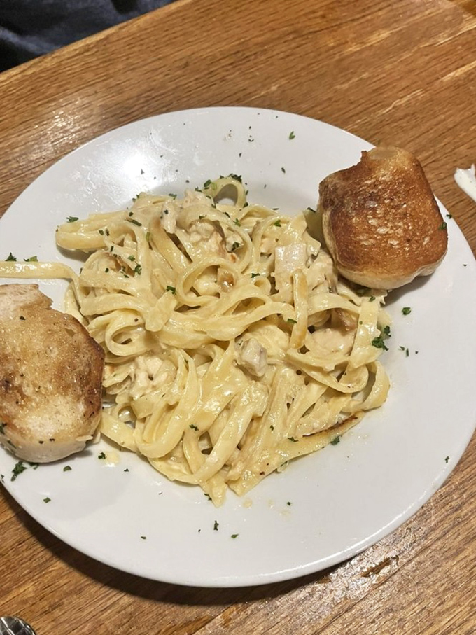 Fettuccine Alfredo that doesn't apologize for its richness, paired with rolls that understand their job is to soak up every last drop of sauce.