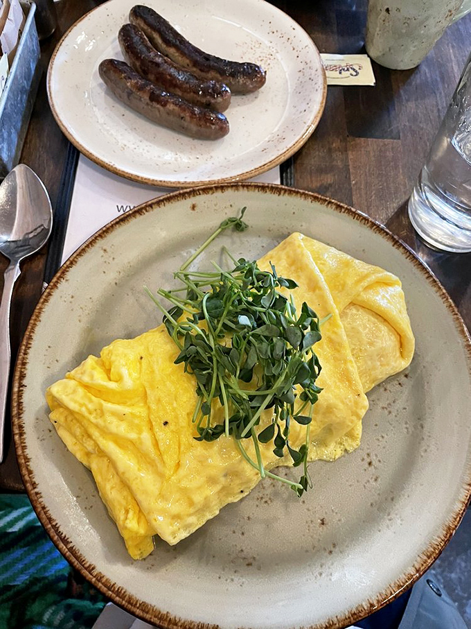 Breakfast alchemy: vibrant eggs, a buttery croissant, and house-made pimento cheese. The morning trinity that makes getting out of bed worthwhile.