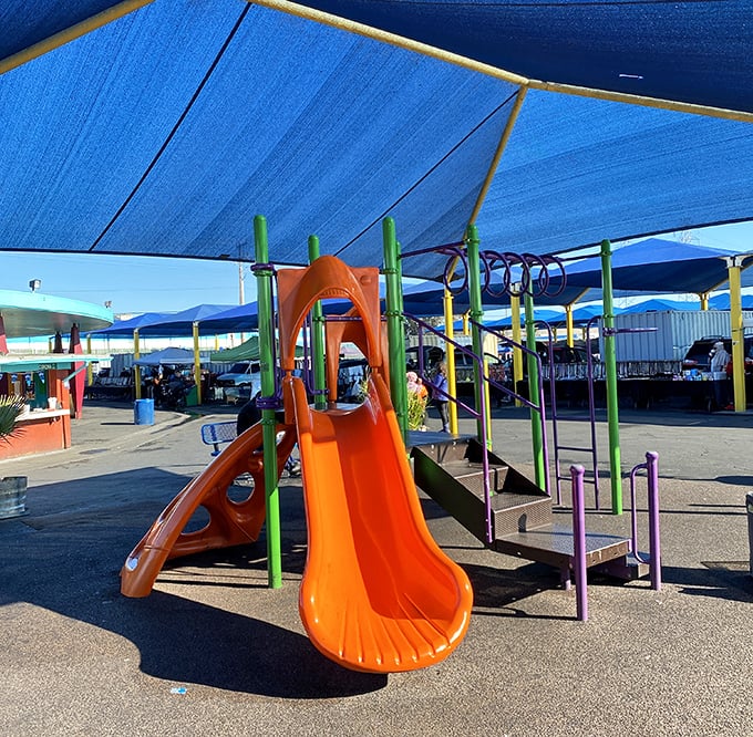 Even the kids get their own slice of swap meet heaven. This playground offers the perfect negotiation tool: "Two more booths, then slide time!"