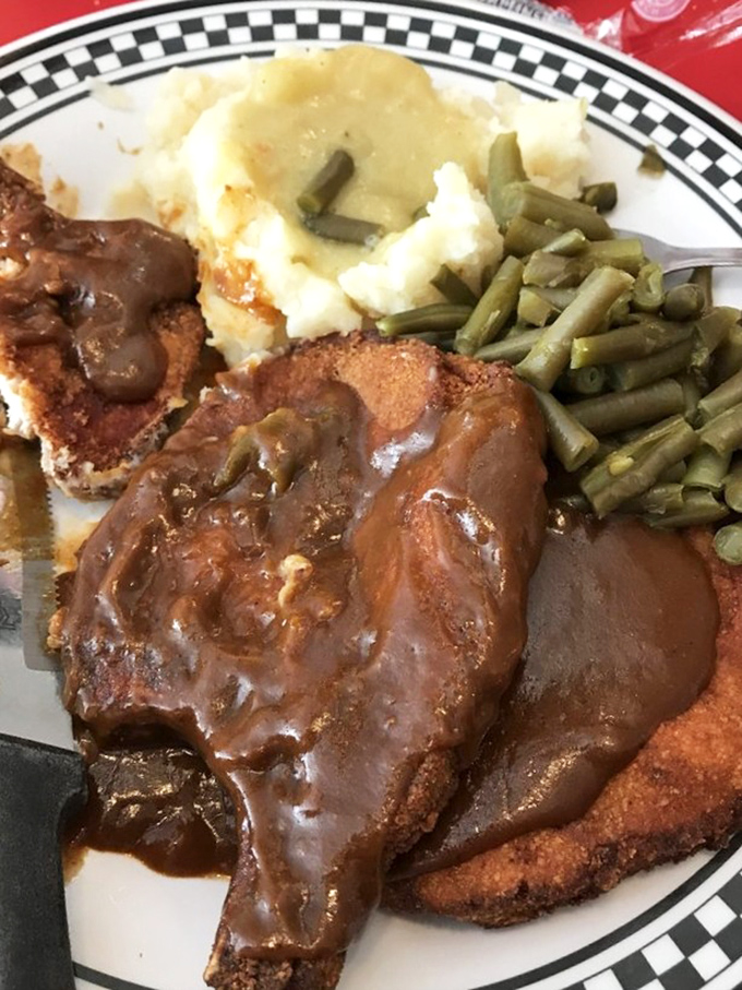 This isn't just country-fried steak &ndash; it's a masterclass in comfort food architecture, with gravy cascading over crispy breading like a savory waterfall.