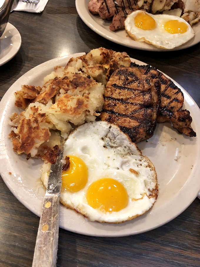 Grill marks on pork chops aren't just decoration&mdash;they're flavor tattoos. Those sunny-side-up eggs are practically winking at you from across the plate. 