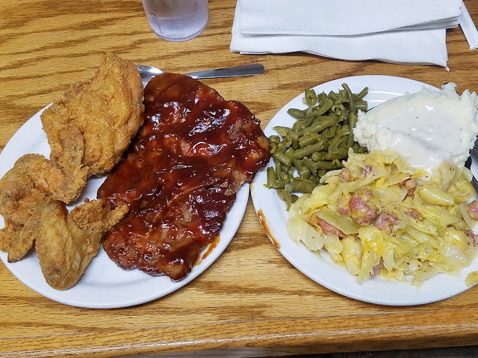 BBQ ribs and fried chicken sharing a plate with perfect harmony&mdash;like the food equivalent of Dolly Parton and Kenny Rogers performing "Islands in the Stream."