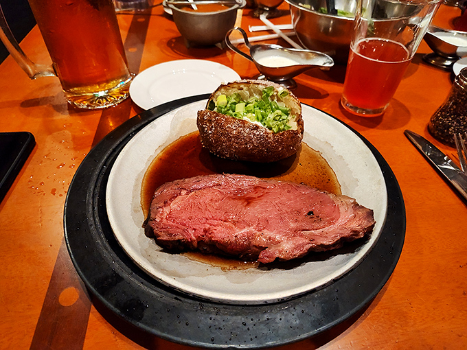 Prime rib so perfectly pink it could make a vegetarian question their life choices. That baked potato isn't just a side&mdash;it's a necessary companion for this journey.