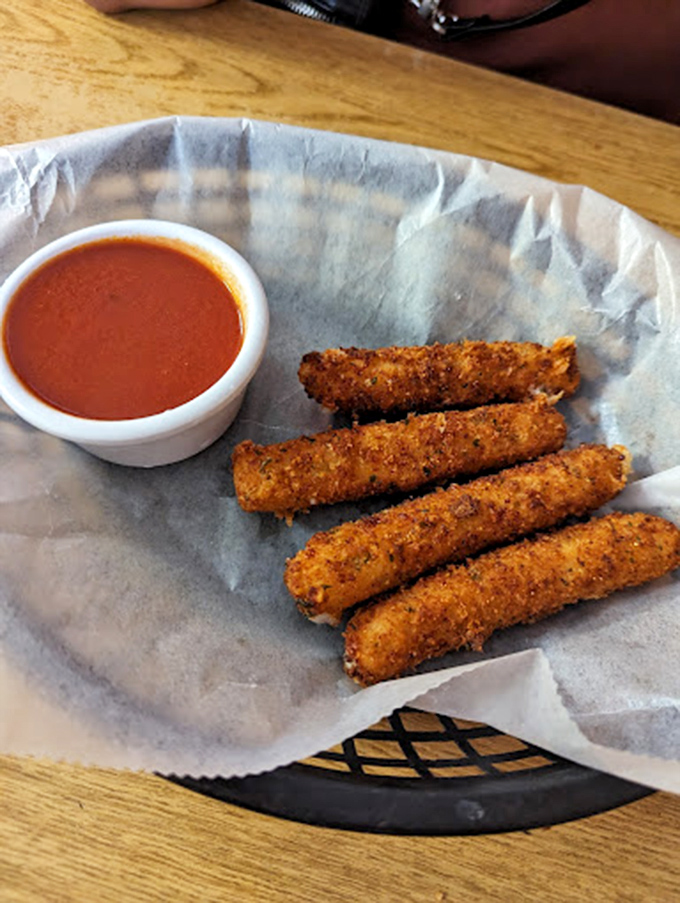 Fried provolone sticks: where cheese meets childhood joy in a crispy golden package. The dipping sauce isn't optional&mdash;it's the law.