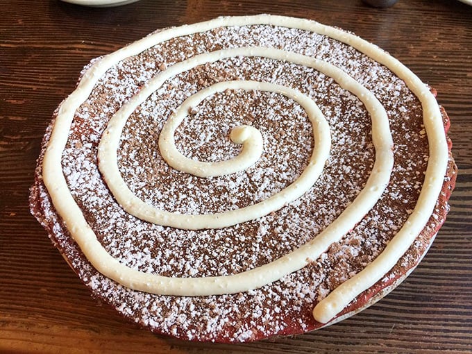 Behold the red velvet pancake in all its spiral-topped glory. It's like someone turned a designer cake into breakfast and then said, "More powdered sugar, please!"