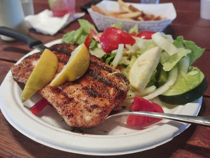 Perfectly seasoned salmon that flakes apart like butter, accompanied by crisp fries that complete this coastal symphony beautifully.