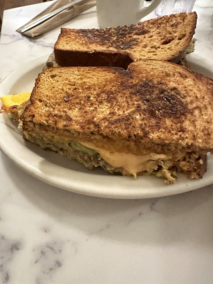 A sandwich that requires both hands and a strategy. That toasted bread cradles its fillings like they're precious cargo&mdash;which, let's be honest, they are. 