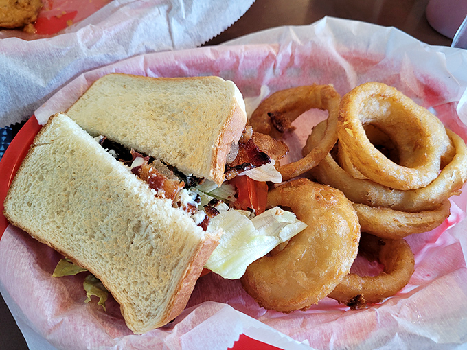 A sandwich that requires both hands and several napkins &ndash; the hallmark of something truly worth eating. Those onion rings aren't just sidekicks; they're co-stars.