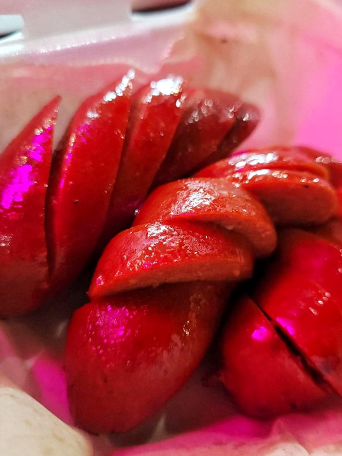 These sausage links glisten with promise, their snappy casings barely containing the juicy, spiced meat within. Texas tradition in every bite.