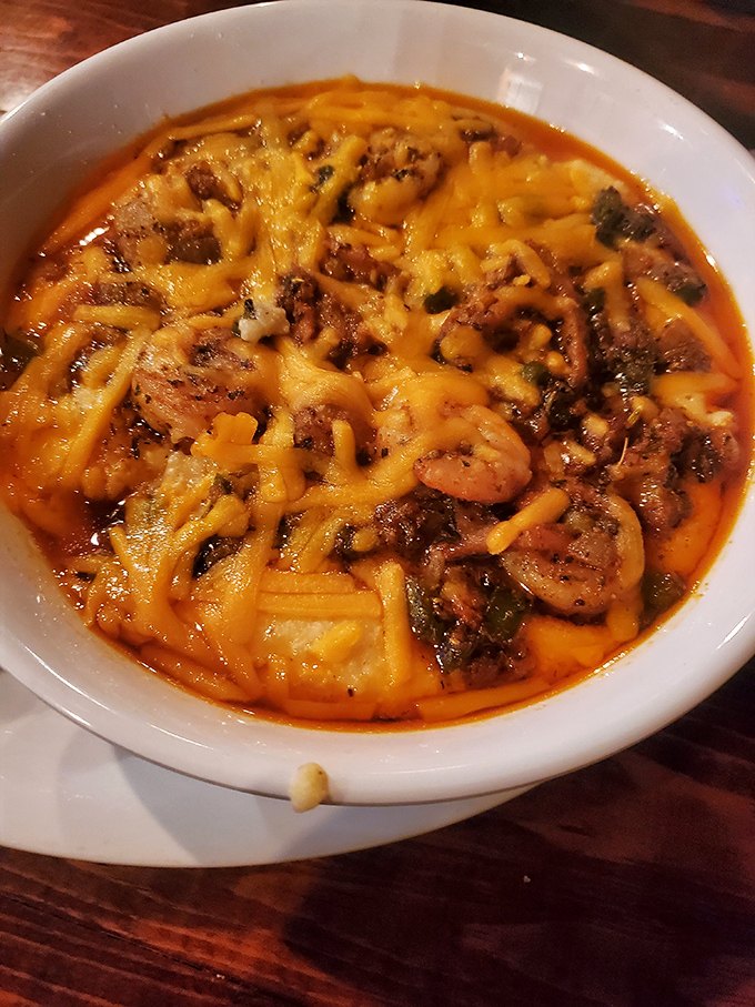 Shrimp and grits swimming in cheesy glory&mdash;the kind of dish that makes you want to hug the chef and steal their recipe.