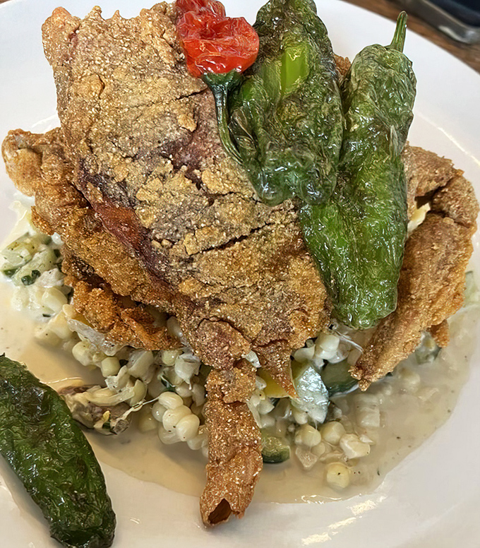 Soft shell crab gets the royal treatment here, perched atop corn like Neptune on his throne of summer's finest treasures.