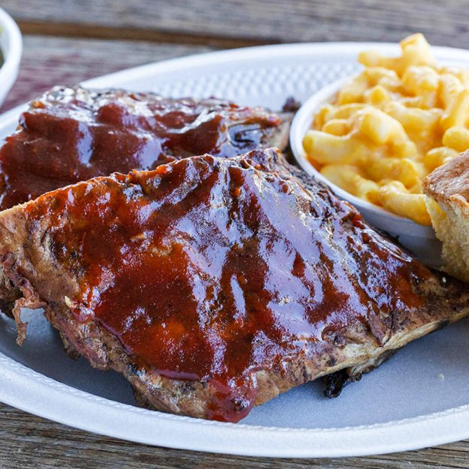 These ribs glisten like mahogany treasures, ready to make your dinner dreams come true.