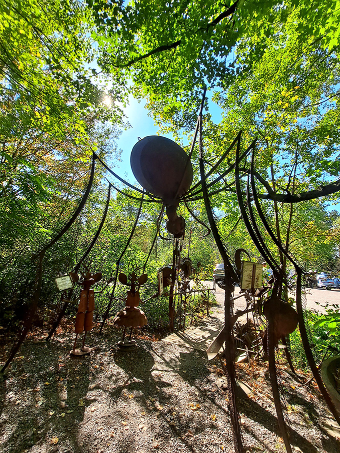 Look up! This magnificent metal spider commands attention from above, its sprawling legs creating a natural archway for adventurous visitors.