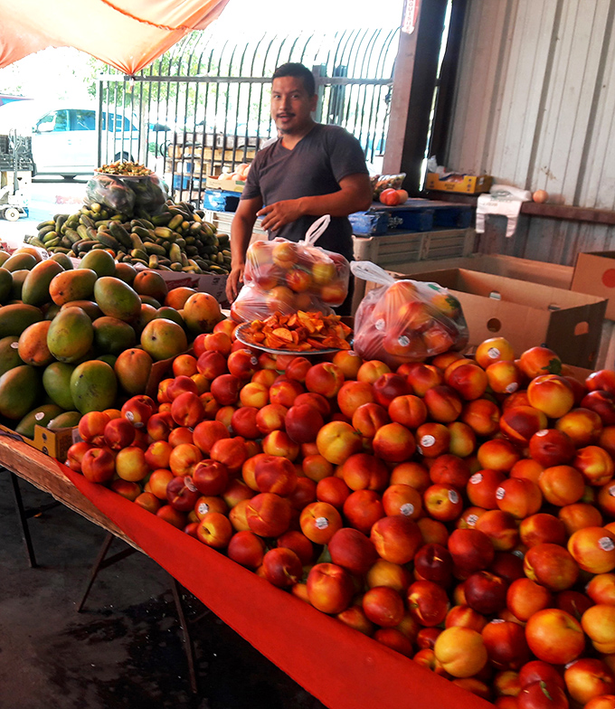 Fruit stand abundance that puts grocery stores to shame &ndash; these peaches and mangoes didn't travel from another hemisphere to meet you.