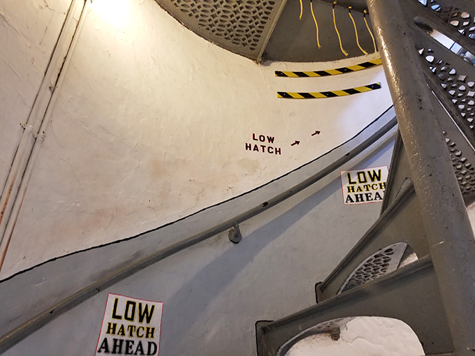 "Low Hatch Ahead" signs warn climbers to duck or suffer the consequences. Lighthouse exploration: part history lesson, part obstacle course.