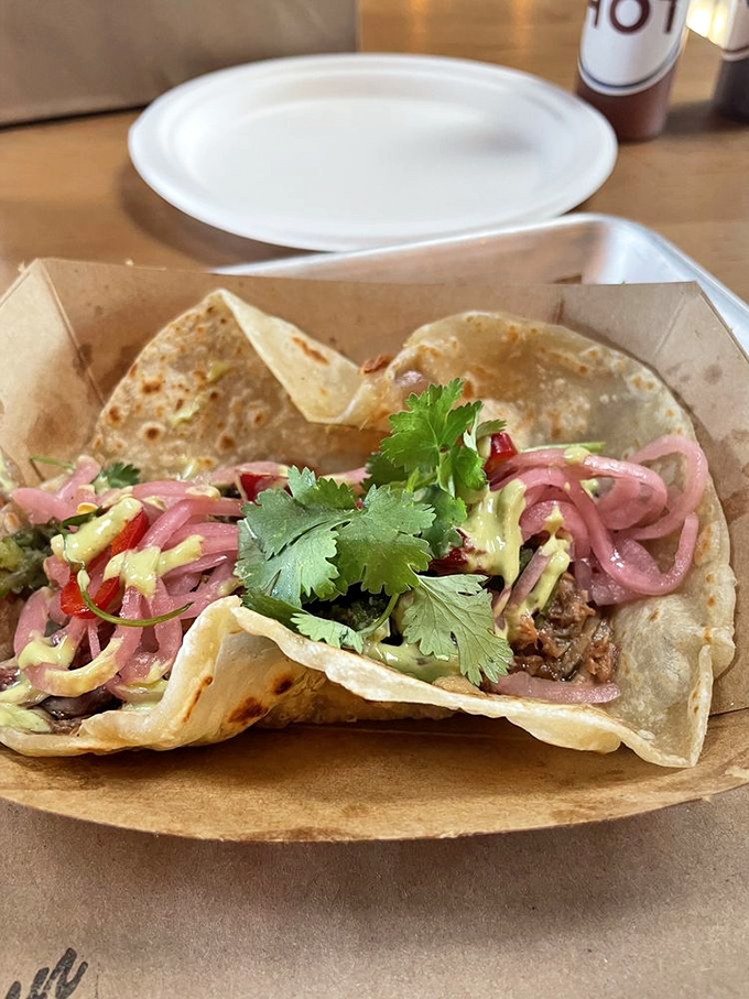 Barbecue meets Mexico in this taco love story. The pickled red onions cut through the richness like your aunt Mildred cuts through small talk.