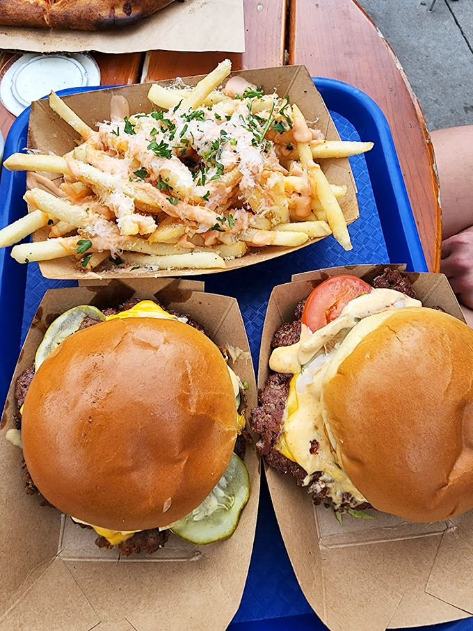 Burger perfection isn't complicated—just impossibly delicious. These beauties with golden buns and melty cheese share the spotlight with parmesan-dusted fries.