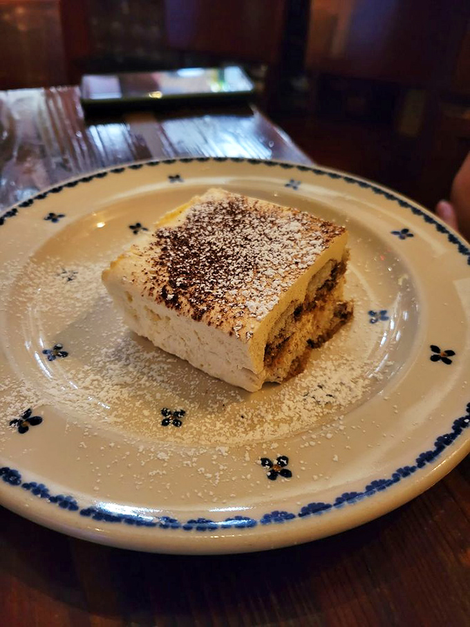 The star of the show: tiramisu that makes time stand still. That perfect dusting of cocoa is like the final brushstroke on an edible masterpiece.