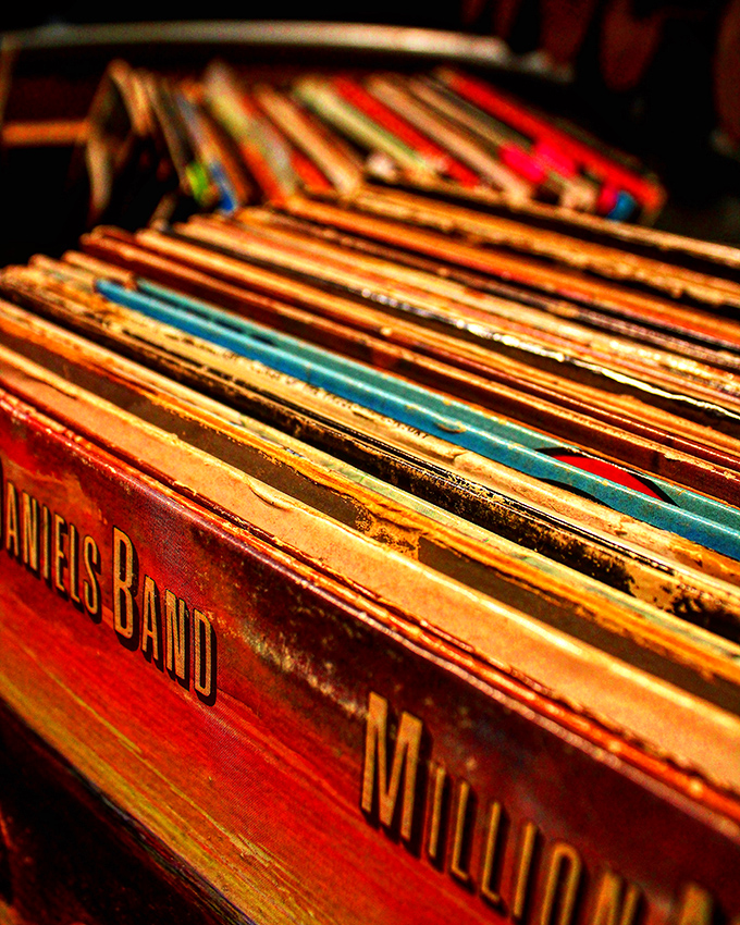 Vinyl records lined up like soldiers of sound, ready to march back into your living room and remind you why analog still matters.