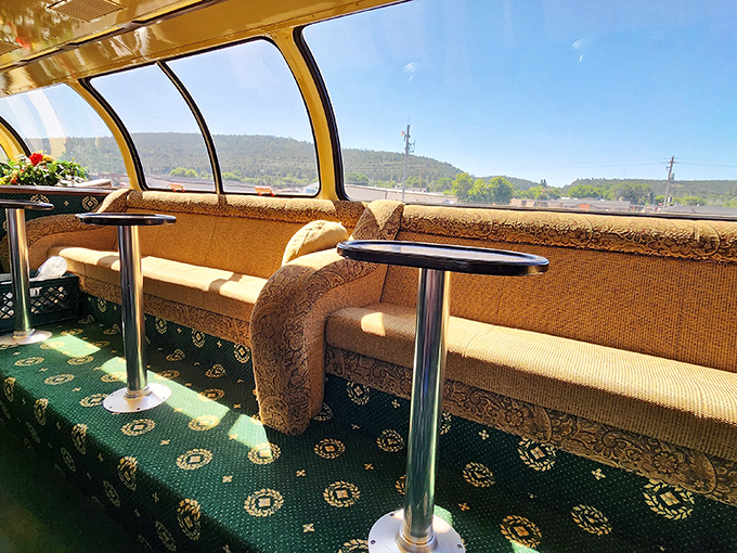 The observation car's panoramic windows frame the passing landscape like living paintings, turning every glance into a postcard moment.