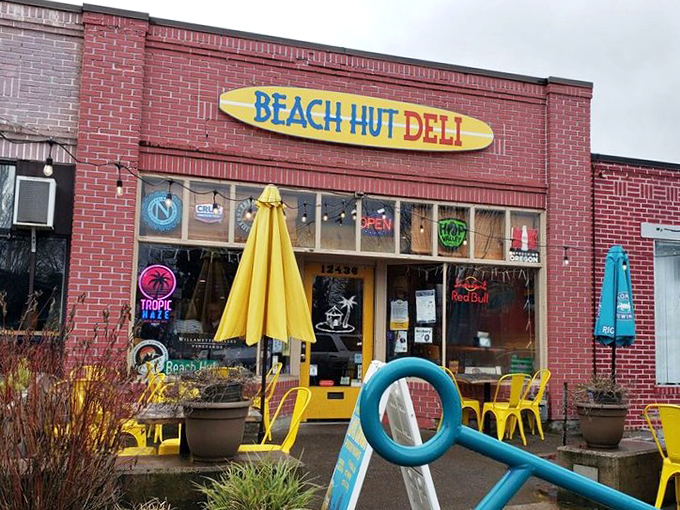 Beach Hut Deli's surfboard sign brings coastal vibes to Tigard&mdash;no sand in your sandwich, just pure flavor waves.