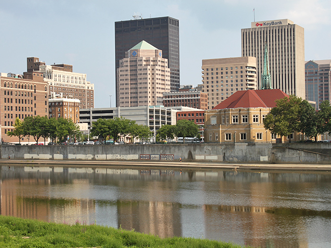 Dayton's riverside skyline reflects perfectly in the water, mirroring the city's balance of beauty and affordability.