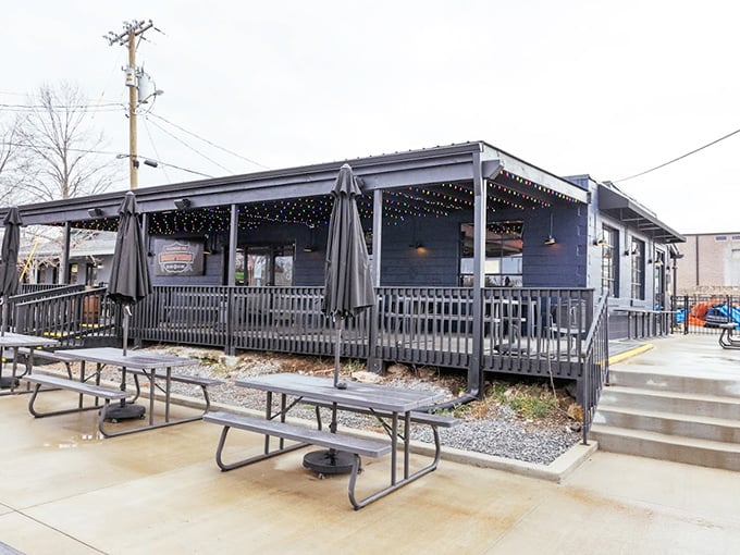 "String lights, picnic tables, and that deep blue exterior&mdash;BBQ paradise awaits on warm Tennessee evenings."
