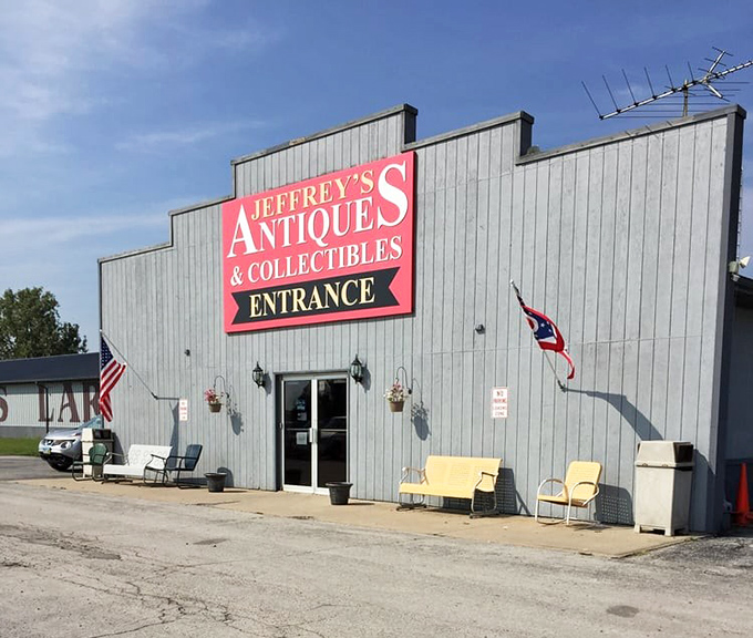 Jeffrey's Antiques announces itself with patriotic flair and vintage porch seating. Even the building looks ready to tell stories!