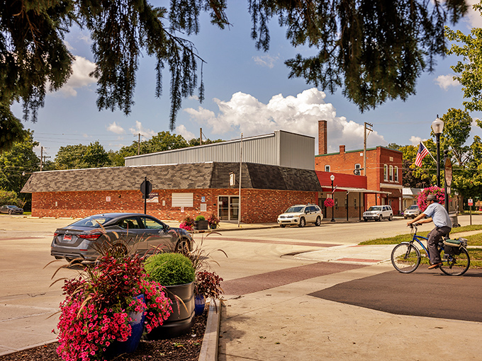 Millersburg's town square bursts with vibrant flower planters and small-town charm. Even passing cyclists slow down to appreciate those crimson blooms against brick buildings.