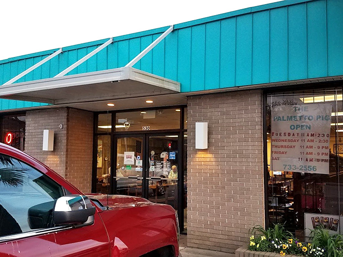Palmetto Pig's turquoise roof stands out like a peacock at a chicken convention. What sandwich treasures await inside?