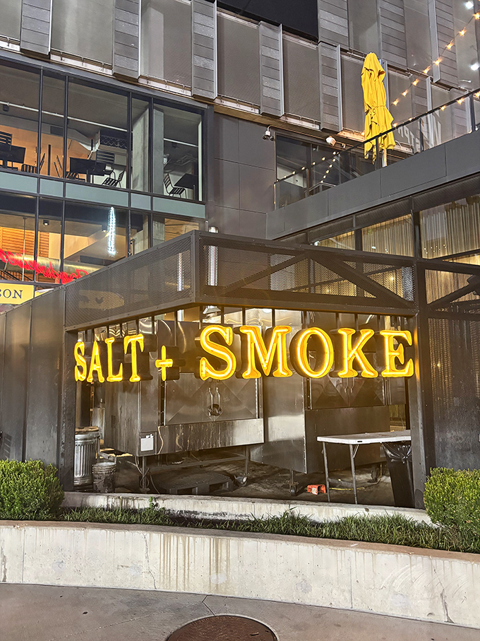 Salt + Smoke's modern exterior and glowing signage hint at the culinary magic happening inside this BBQ-meets-seafood haven.