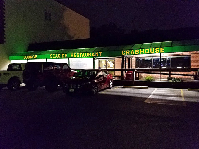 Seaside's glowing green sign cuts through the night, a beacon for those seeking crab imperial salvation.