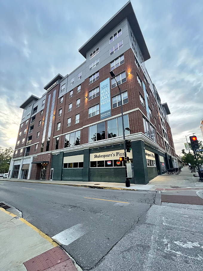 Shakespeare's Pizza stands tall among modern apartments, a testament that some traditions are too delicious to be replaced.