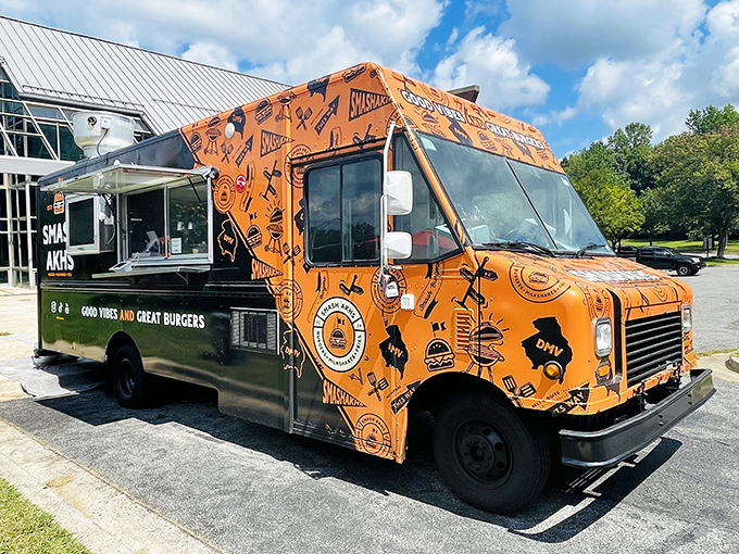 Smash Akhs' vibrant orange food truck is like a rolling sunset filled with burger goodness. Spot it and your lunch plans are instantly upgraded!
