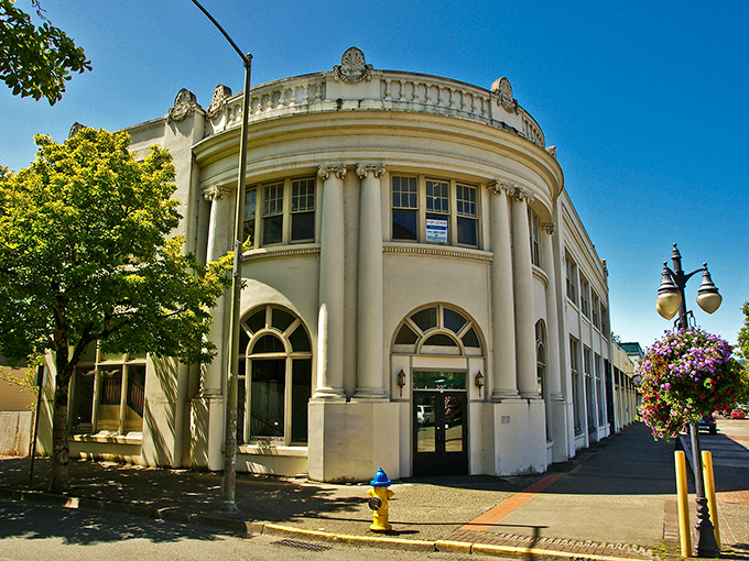 Banners wave welcome in downtown Coos Bay, where the rhythm of tides has shaped both commerce and community. 