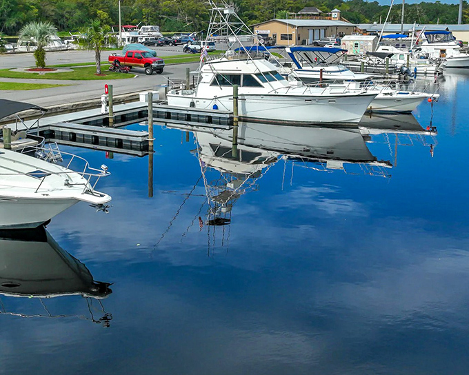 Reflections run deep in DeLand&rsquo;s serene marina, where calm waters and docked boats set the tone for a relaxing day by the water.