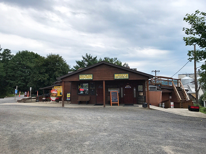 The sign promises "Denny's Beer Barrel Pub" but the real draw is their legendary burgers that challenge both plate and appetite.