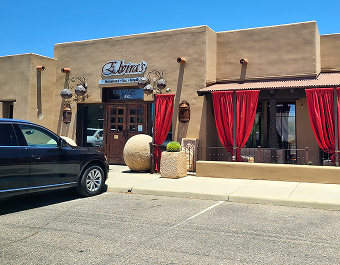 Elvira's elegant facade blends Southwestern architecture with theatrical flair. Those red curtains hint at the culinary performance waiting inside.